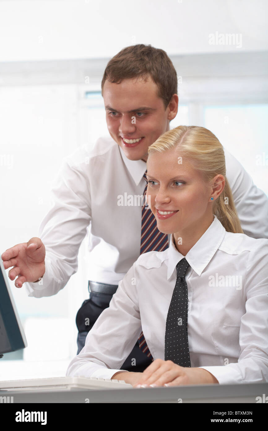 Successful businessman explaining something to his pretty colleague ...