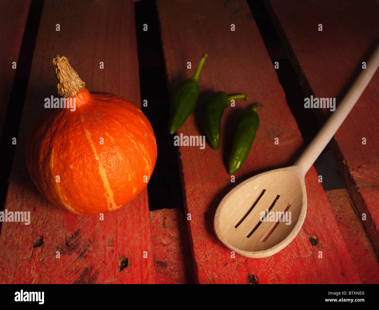 Pumpkin squash and green chili peppers Stock Photo - Alamy