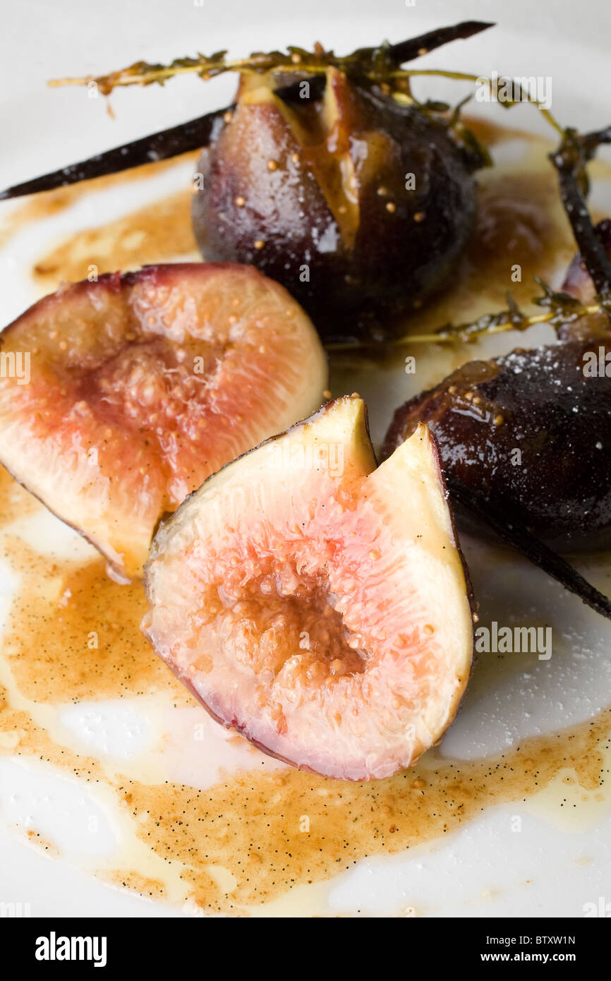 Roasted figs Black figs served with amaretto and vanilla pods. Photo ...