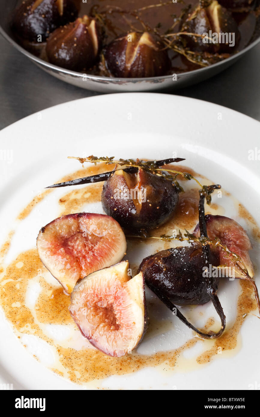Roasted figs Black figs served with amaretto and vanilla pods. Photo ...