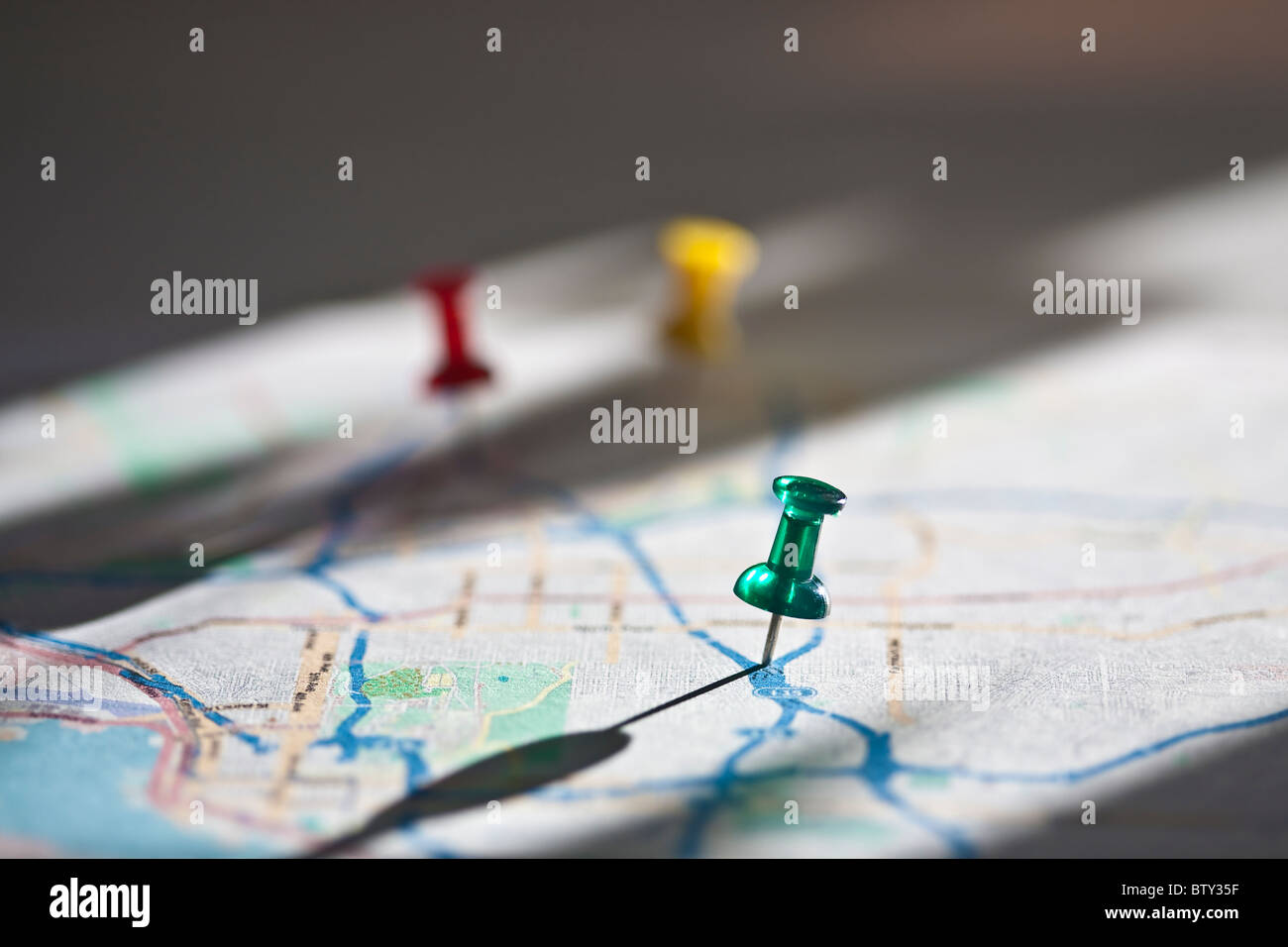 colored push-pins in colorful paper map Stock Photo - Alamy