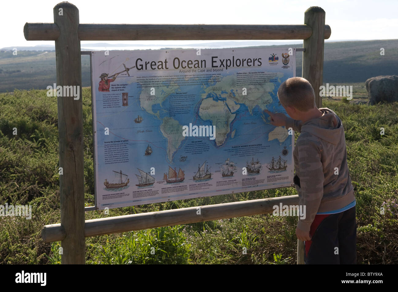 Boy looking at a map of the world Stock Photo - Alamy