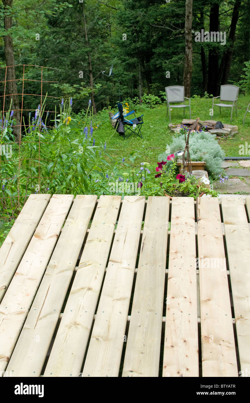 outdoor deck overlooking a lush green yard Stock Photo - Alamy
