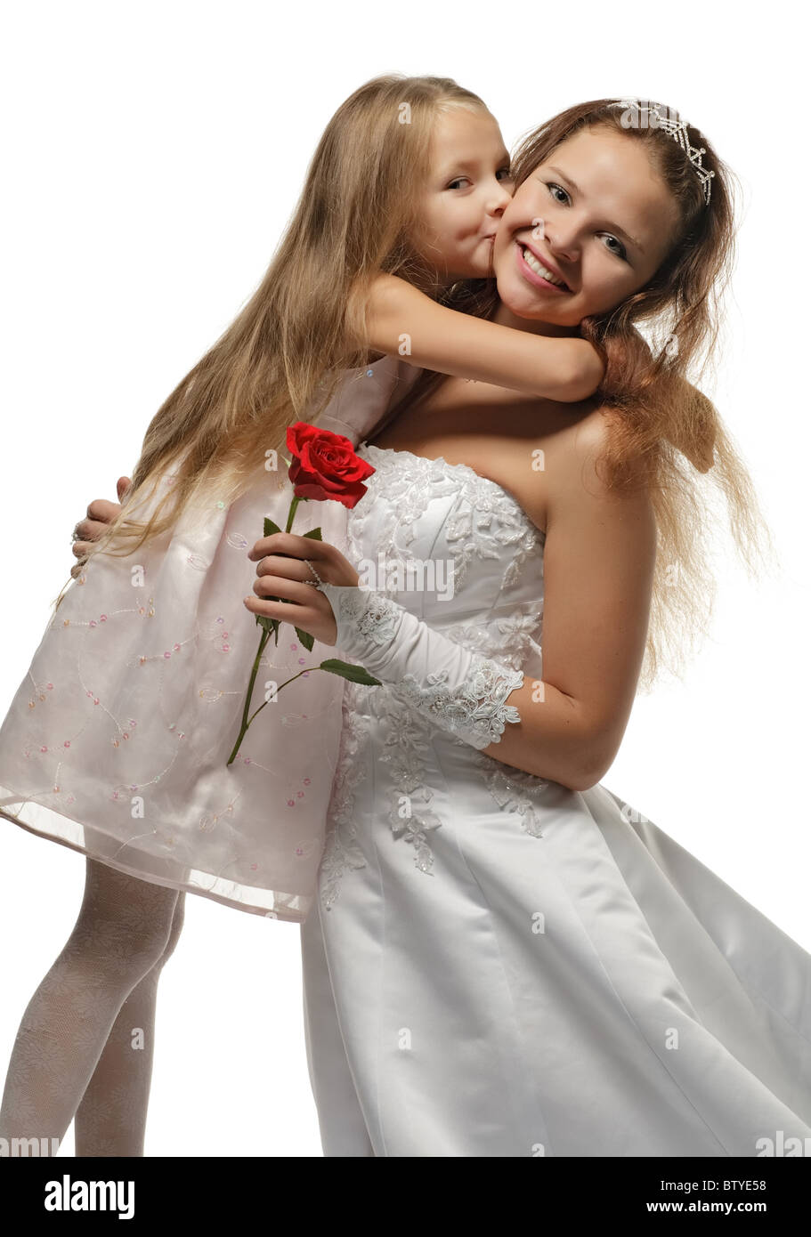 beautiful bride with little girl in white dress and red rose in hand ...