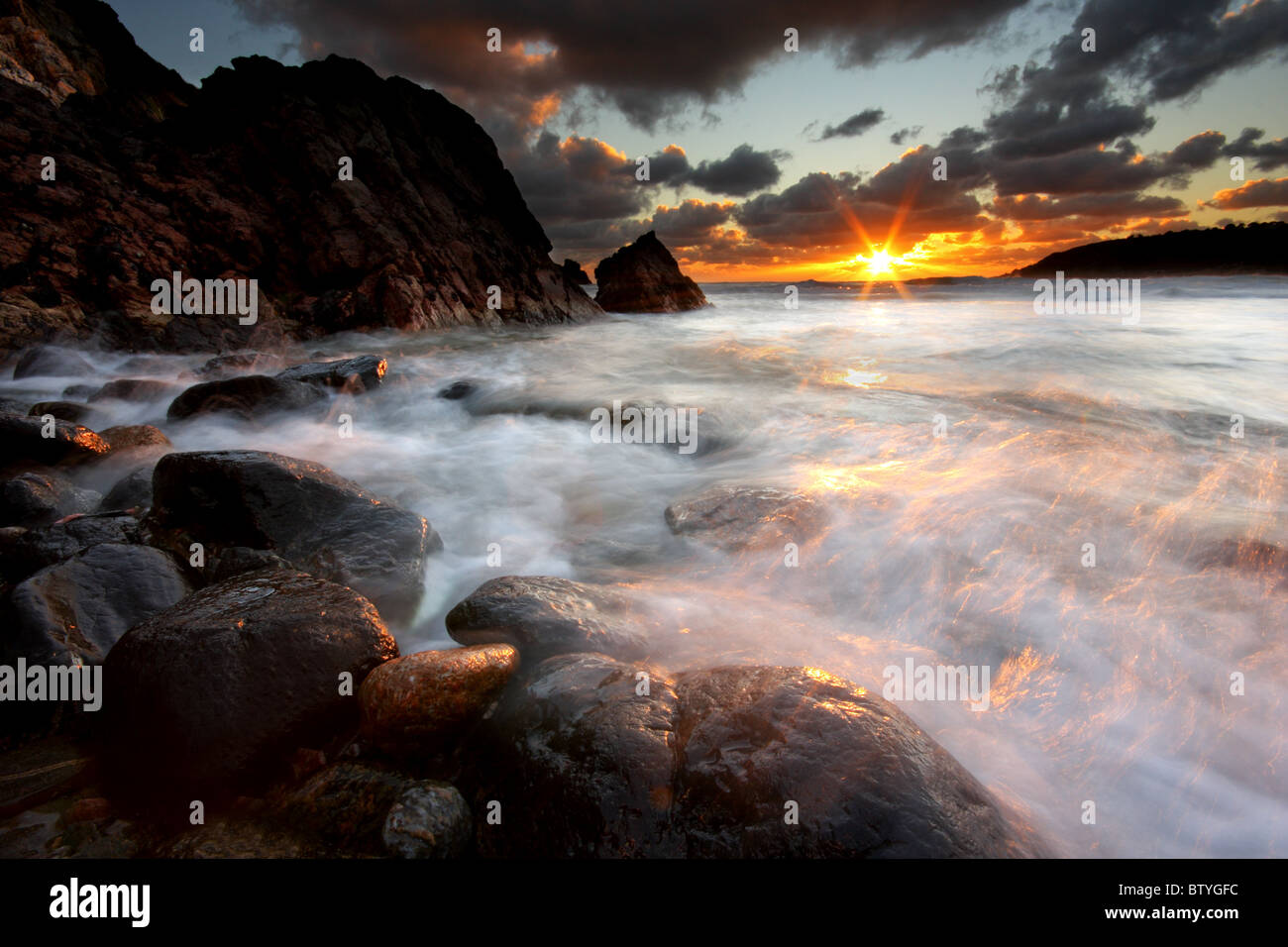 The wet rocks of Petit Port Stock Photo - Alamy
