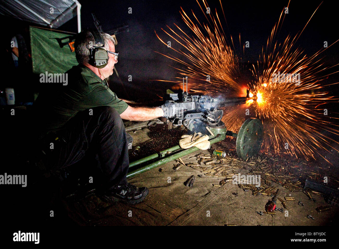A MAN FIRING A MACHINE GUN AT THE Machine gun party in wyandotte ...