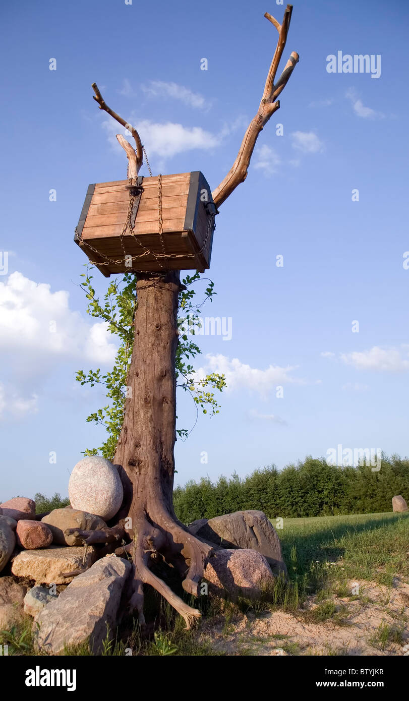 Old tree with antique chest on sky background Stock Photo - Alamy