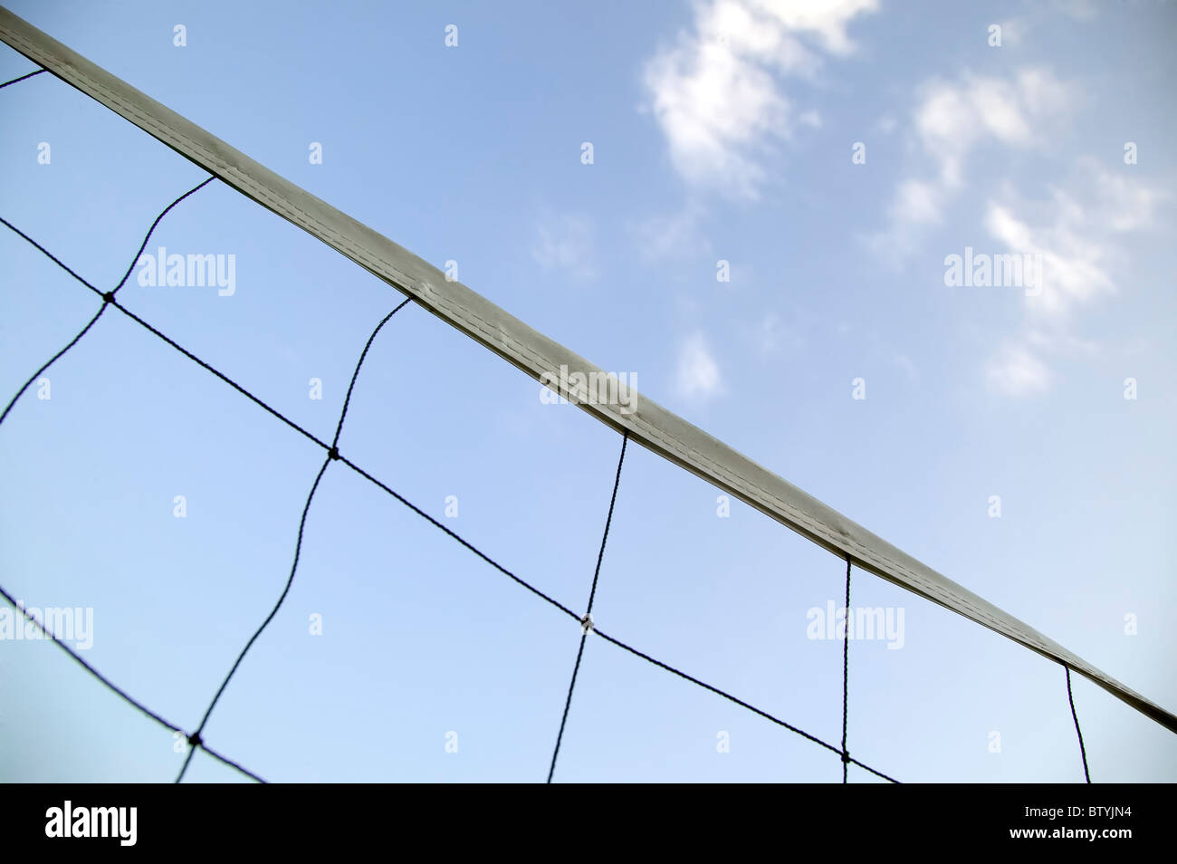 Tennis net with blue cloudy sky background Stock Photo - Alamy