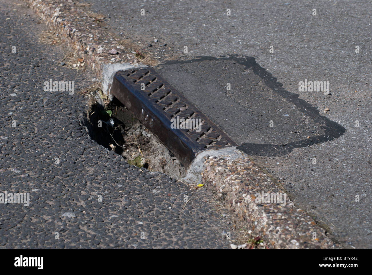 Damaged road drain Stock Photo - Alamy