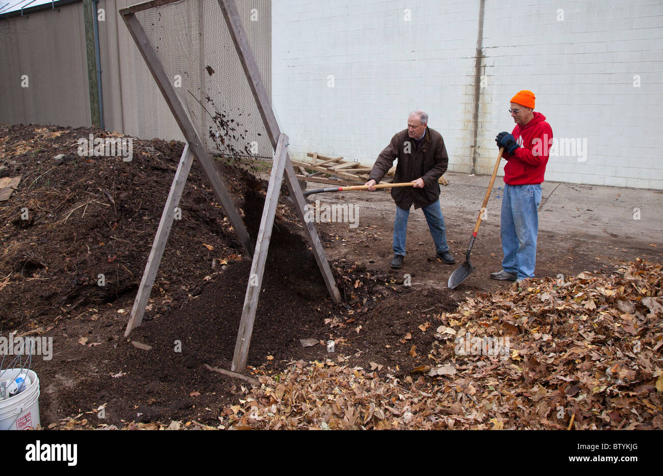 Detroit, Michigan - Two men shovel compost through a screen at the ...