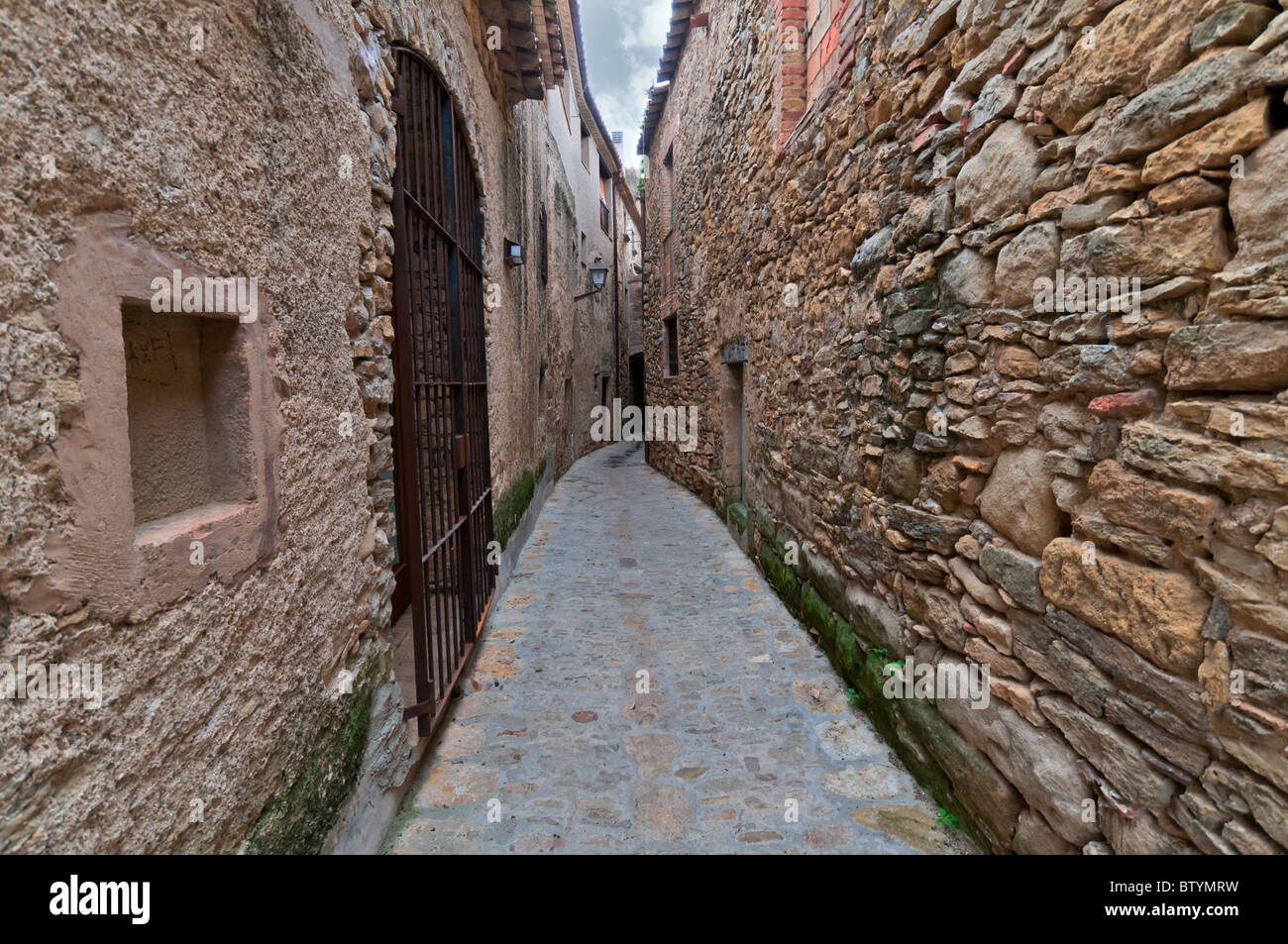 Narrow passageway between two walls in Peratallada, Spain Stock Photo ...