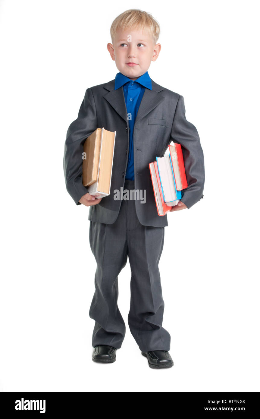Young serious boy , dressed as professor, holding books under his arms ...