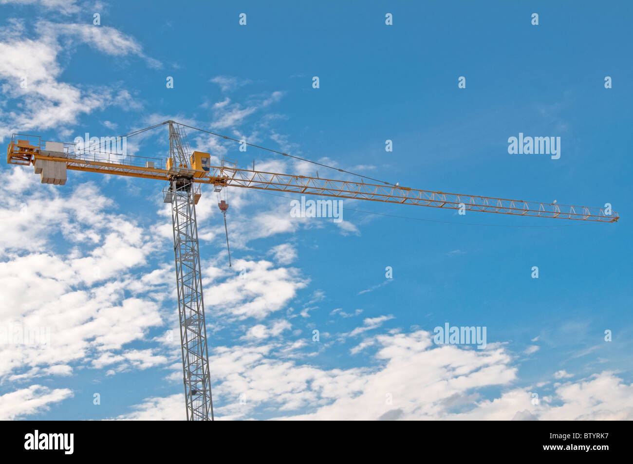 big yellow crane on blue sky with clouds background Stock Photo - Alamy