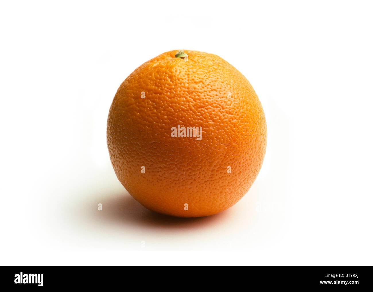 A single orange on a white surface Stock Photo - Alamy