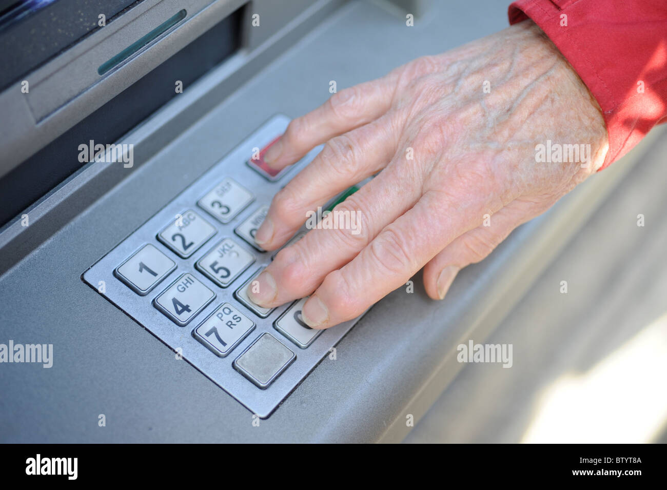 pensioner using cash point in london Stock Photo - Alamy