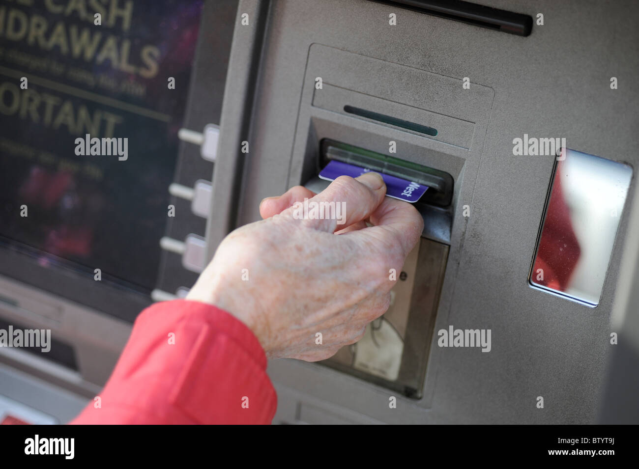 pensioner using cash point in london Stock Photo - Alamy