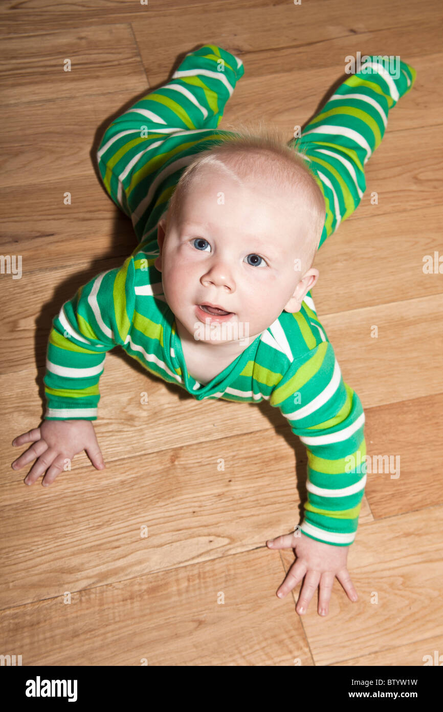 Baby crawling on the floor Stock Photo - Alamy