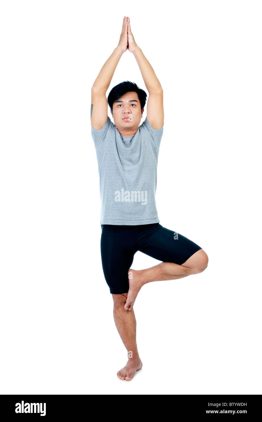 Handsome young man in yoga pose Stock Photo - Alamy
