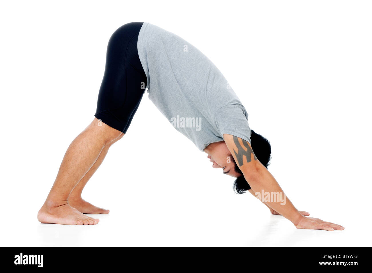 Handsome young man in yoga stance Stock Photo - Alamy