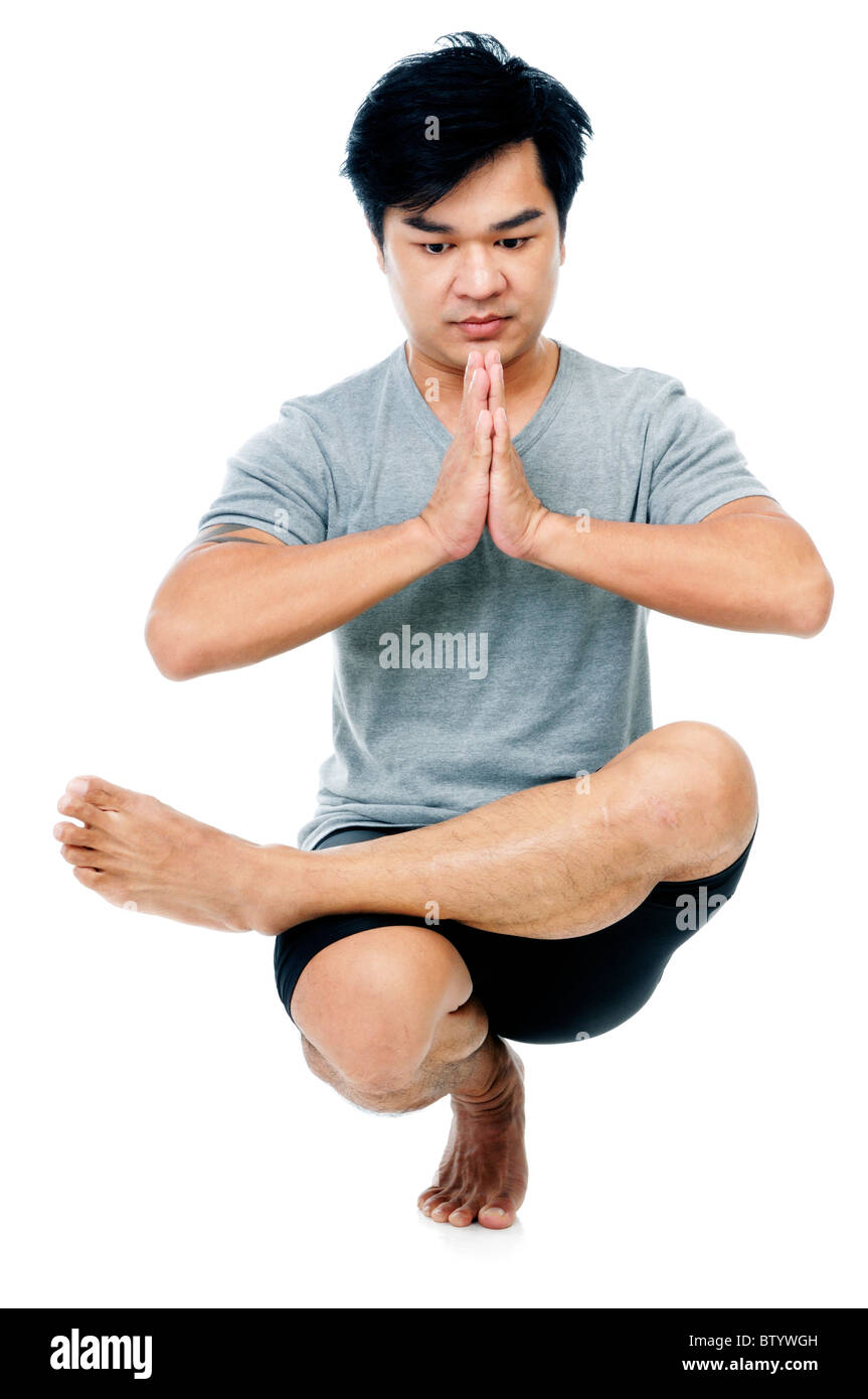 Handsome young man in yoga stance Stock Photo - Alamy