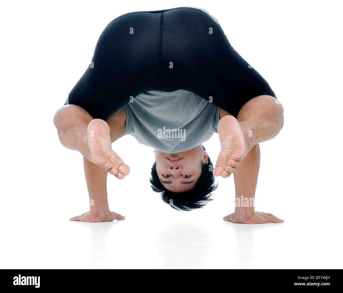 Handsome young man in yoga stance Stock Photo - Alamy