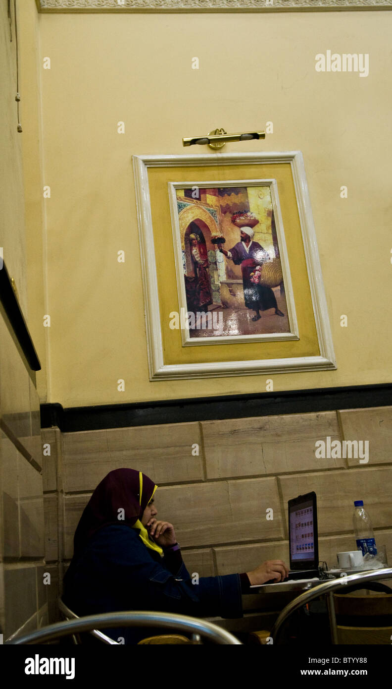 Working on her laptop computer at Cairo's railway station Stock Photo ...