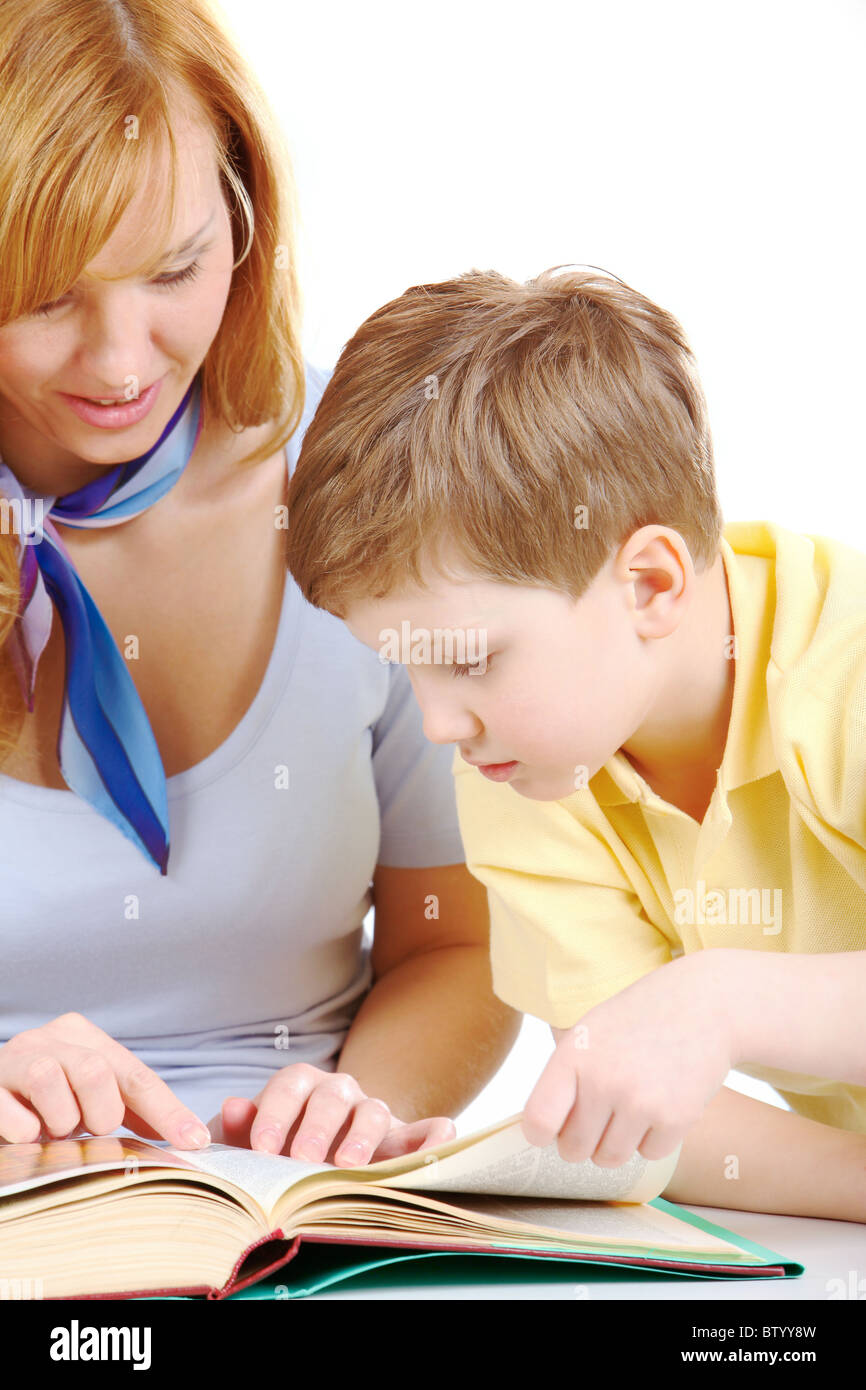 Photo of cute preschooler and his mother looking into book Stock Photo ...