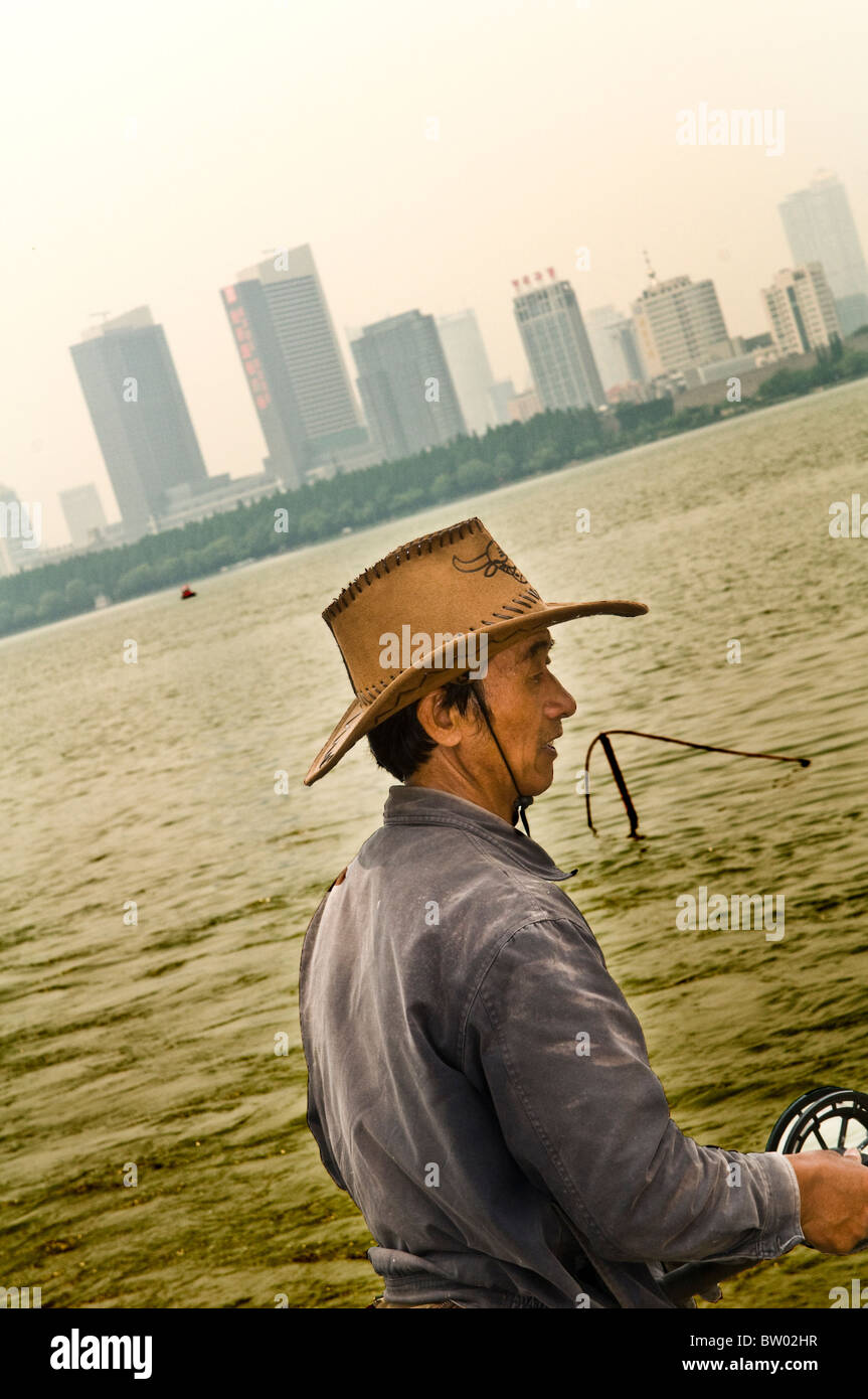 A Chinese man fishing at the beautiful Xuanwu lake in Nanjing Stock ...