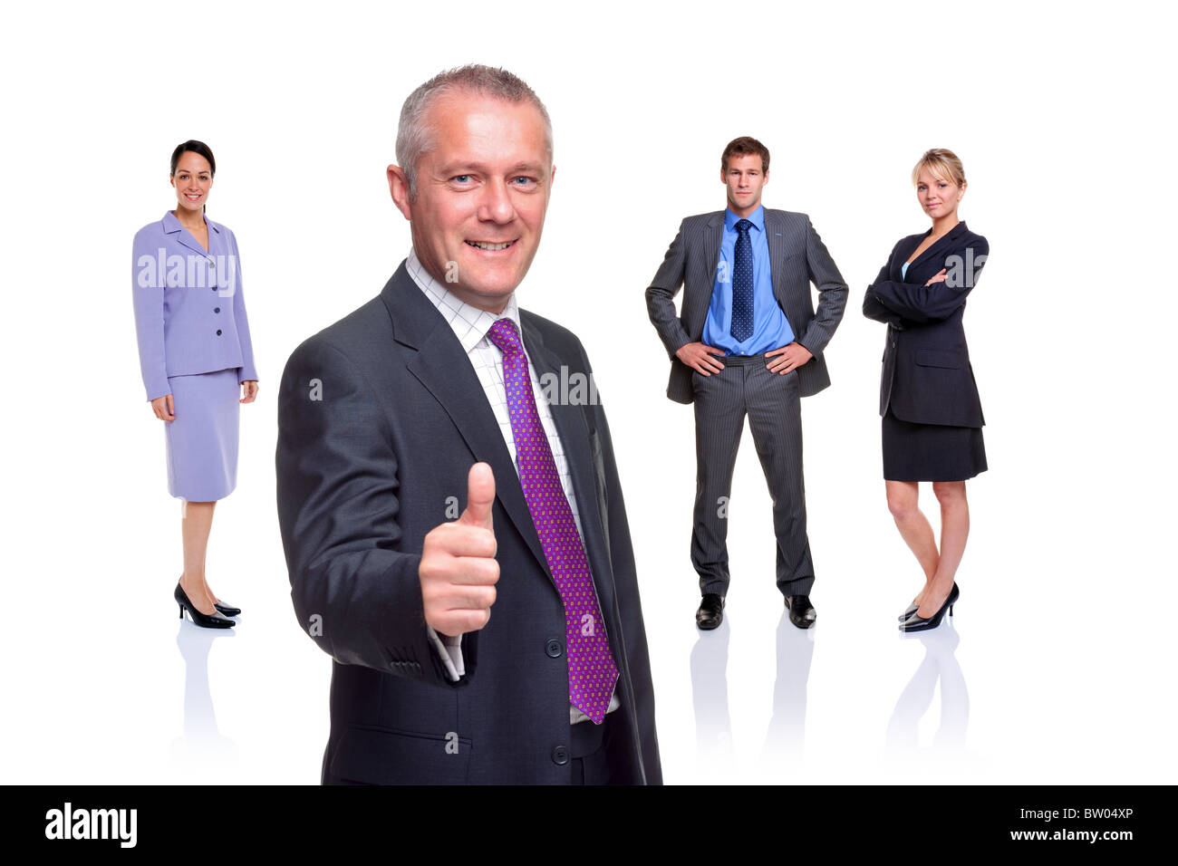 A manager gesturing a thumbs up with a business team behind, isolated ...