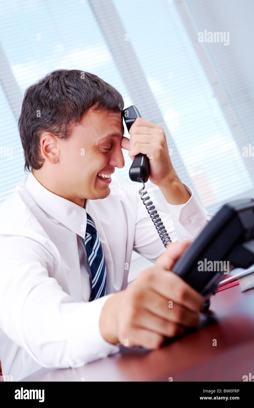 Portrait of frustrated employer with phone receiver at workplace Stock ...