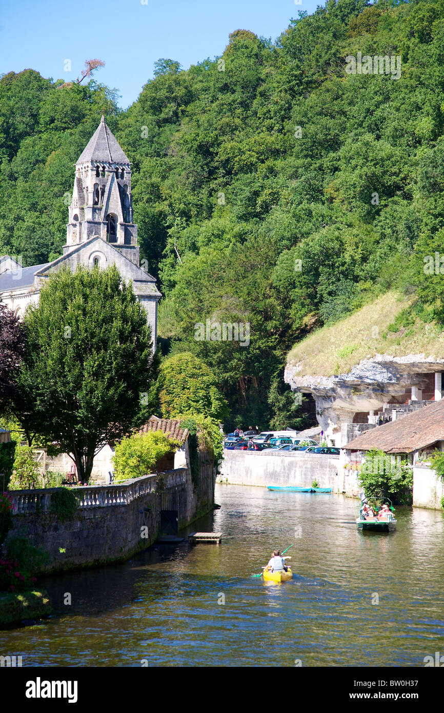 The winding River Dronne with canoes and pleasure boat at Brantome ...