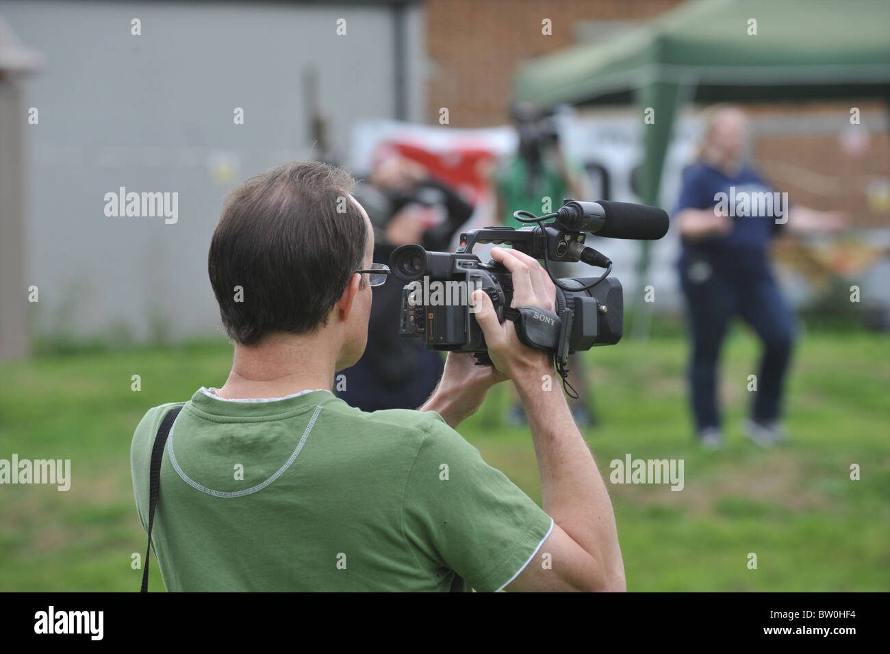 Camera man filming an outdoor event Stock Photo - Alamy