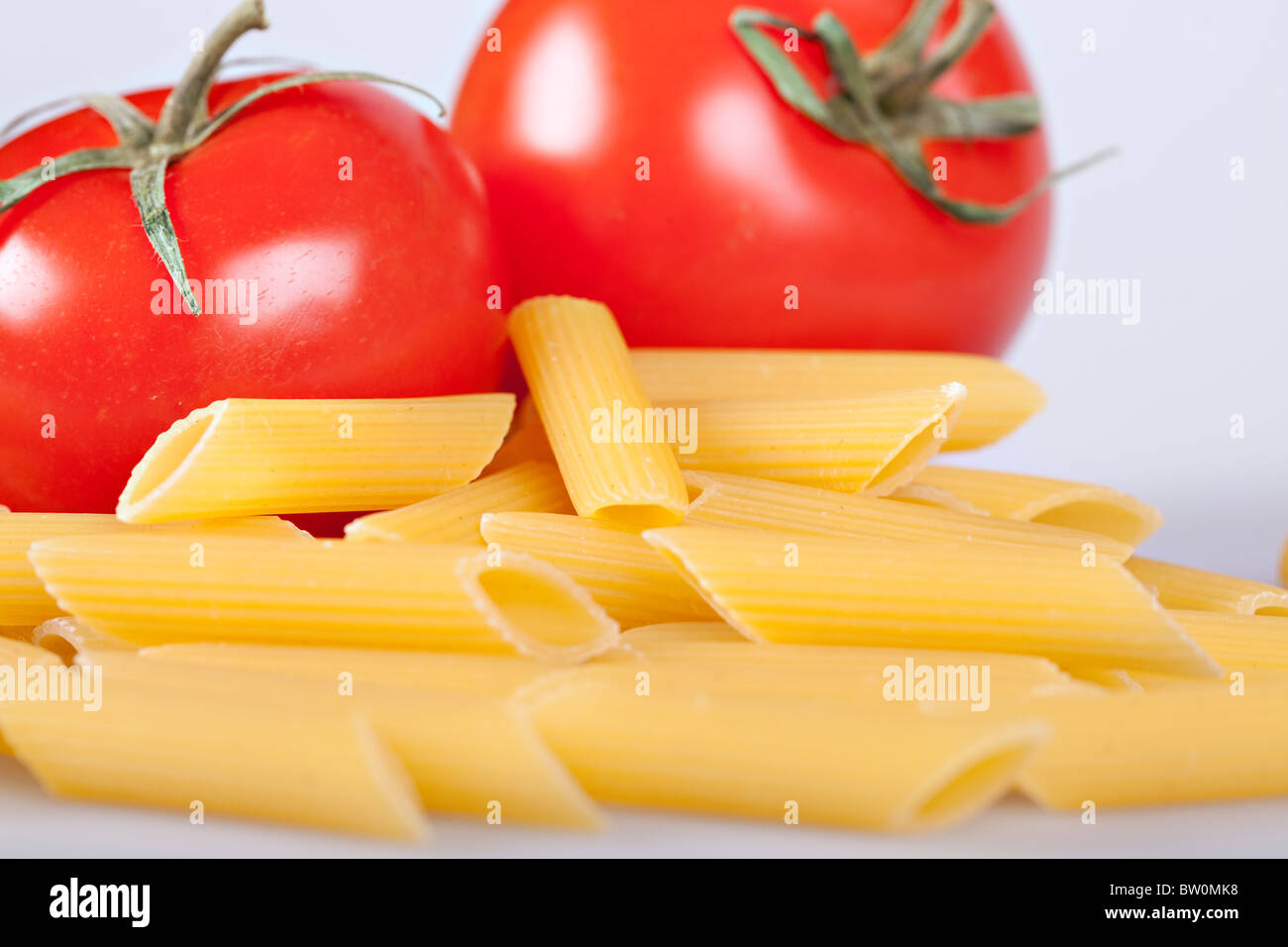penne rigate, italian pasta on white Stock Photo - Alamy