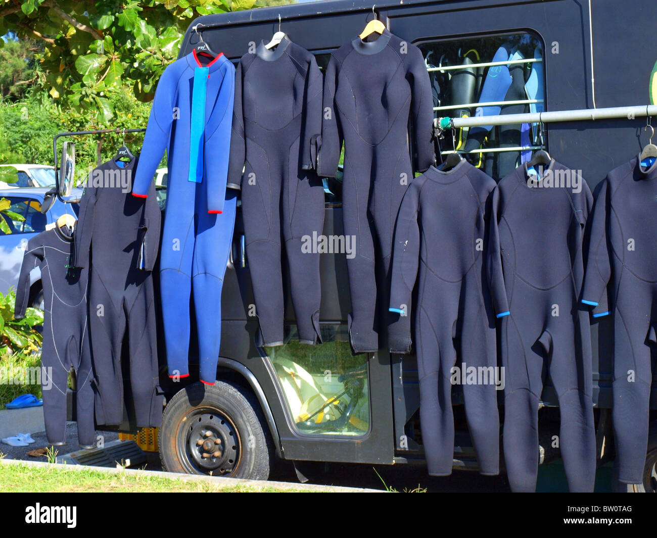 Wet suits drying on the side of a van Stock Photo - Alamy