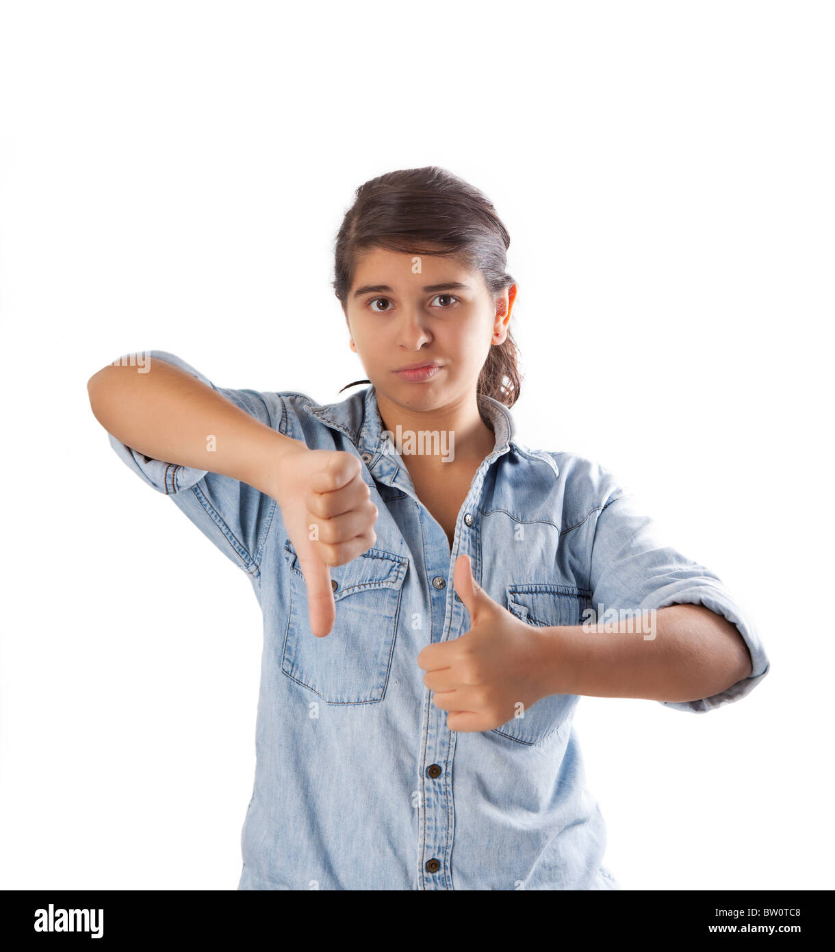 Young teenage girl gesturing one thumb up and one thumb down Stock ...