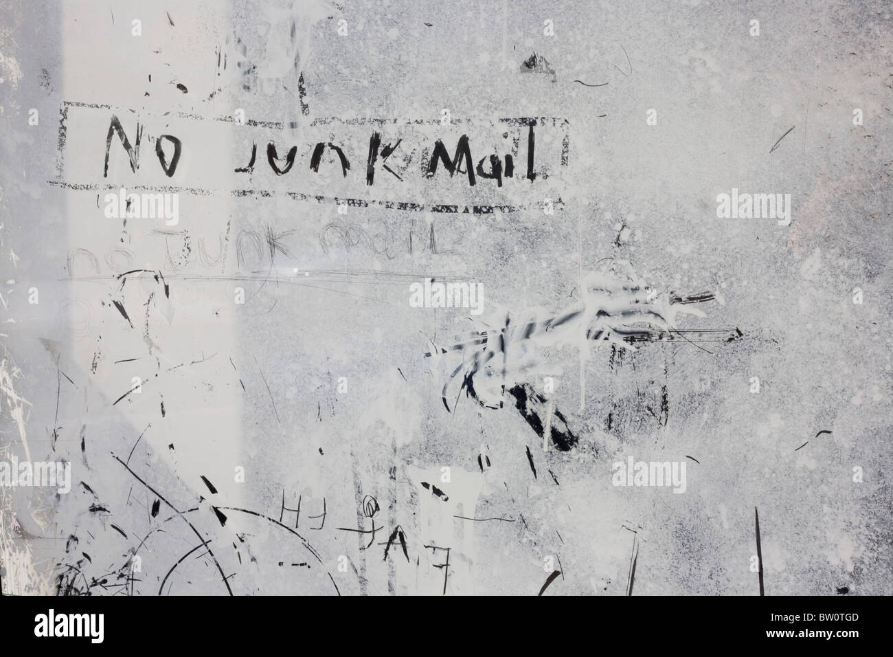 No Junk Mail is scratched into emulsion paint smeared over window of a ...