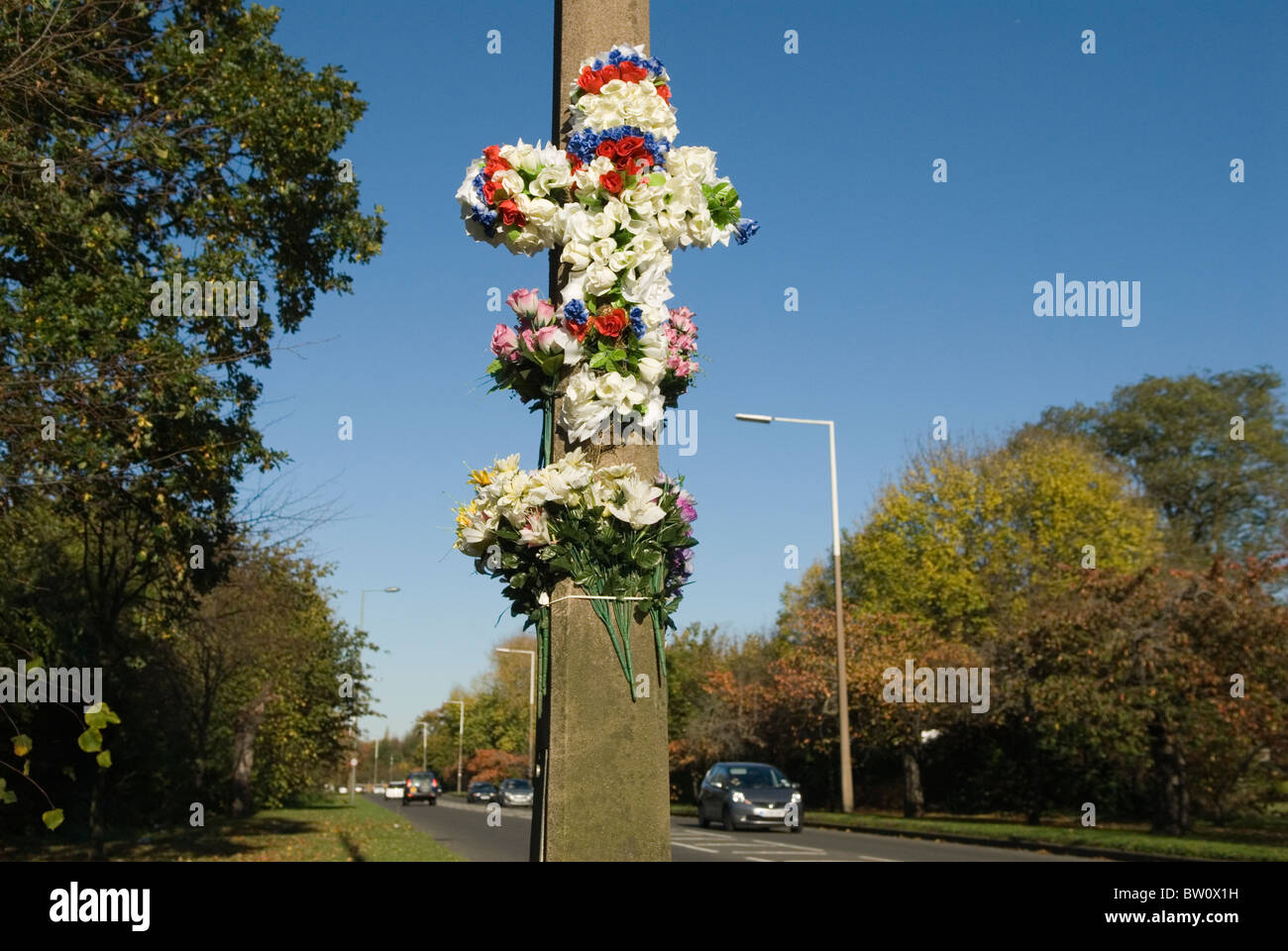 Roadside accident memorial to car crash victim. Cross of plastic ...