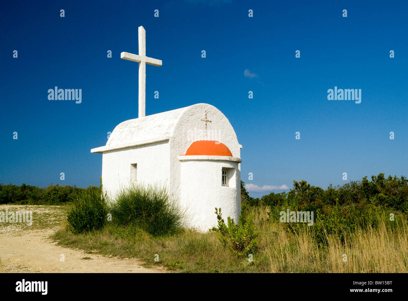 the small church of agios stefanos or san stefanos on headland between ...