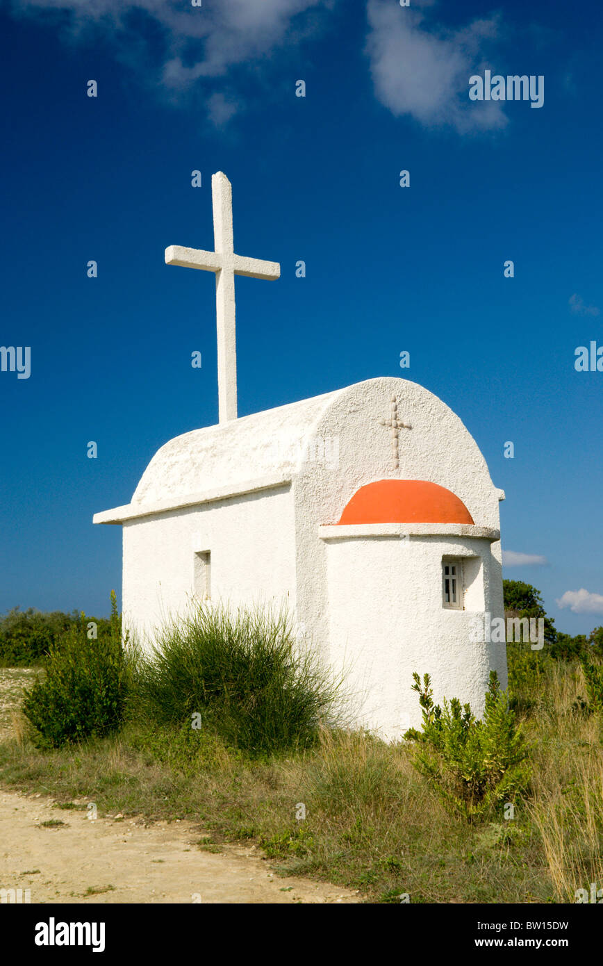 the small church of agios stefanos or san stefanos on headland between ...