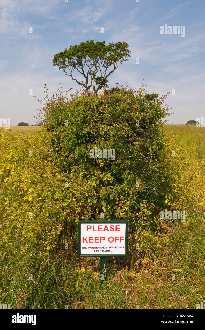 A sign reading Please Keep Off Environmental Stewardship Field Margin ...