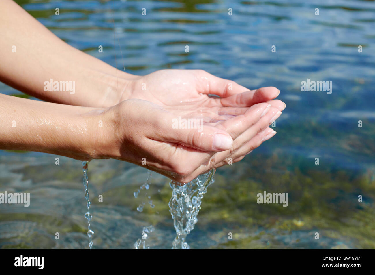 Human hands splashing pure water from river Stock Photo - Alamy