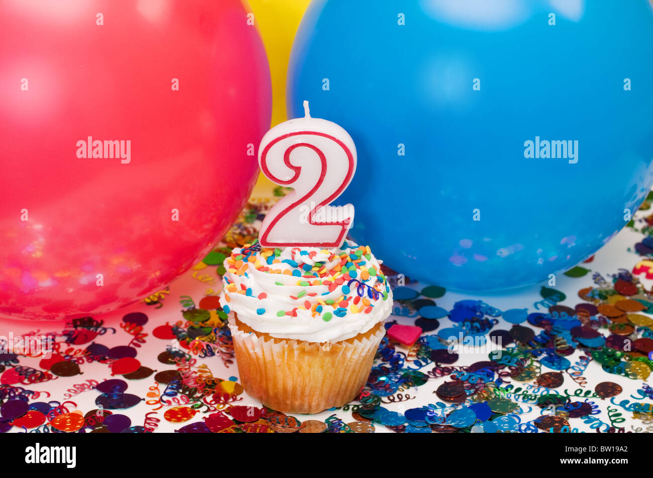 Celebration with balloons, confetti, cupcake, and number 2 candle Stock ...