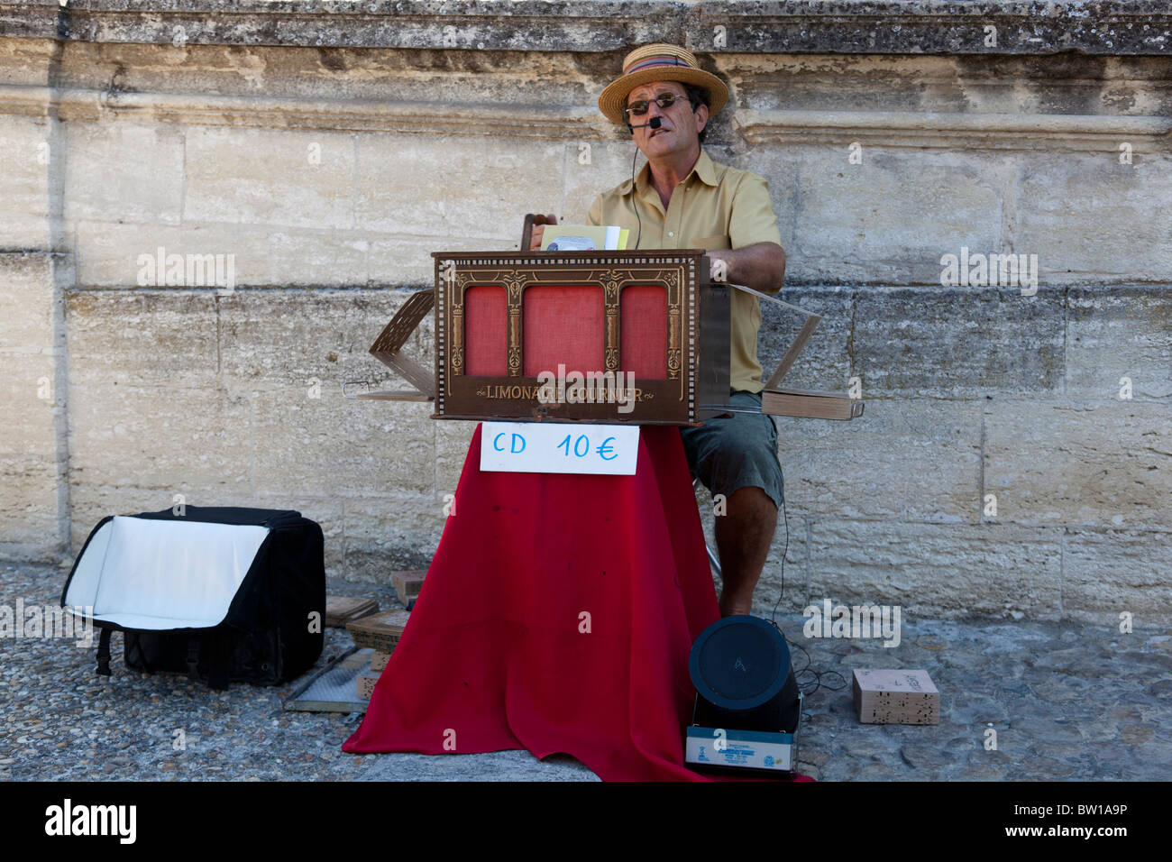 A street musician sings to the accompaniment of a Limonaire Fournier ...