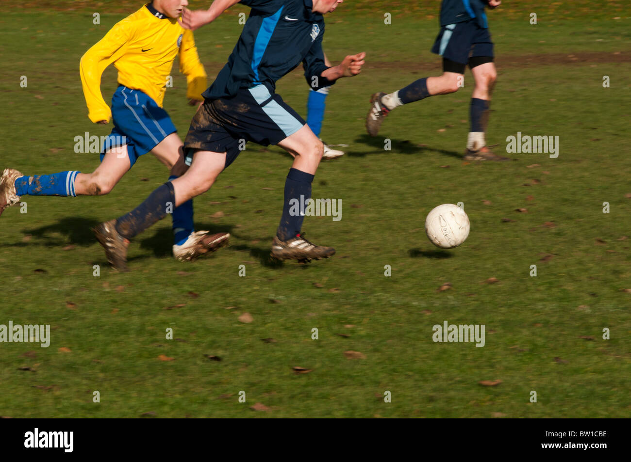 boys playing football in outdoor playing fields close up of boots with ...