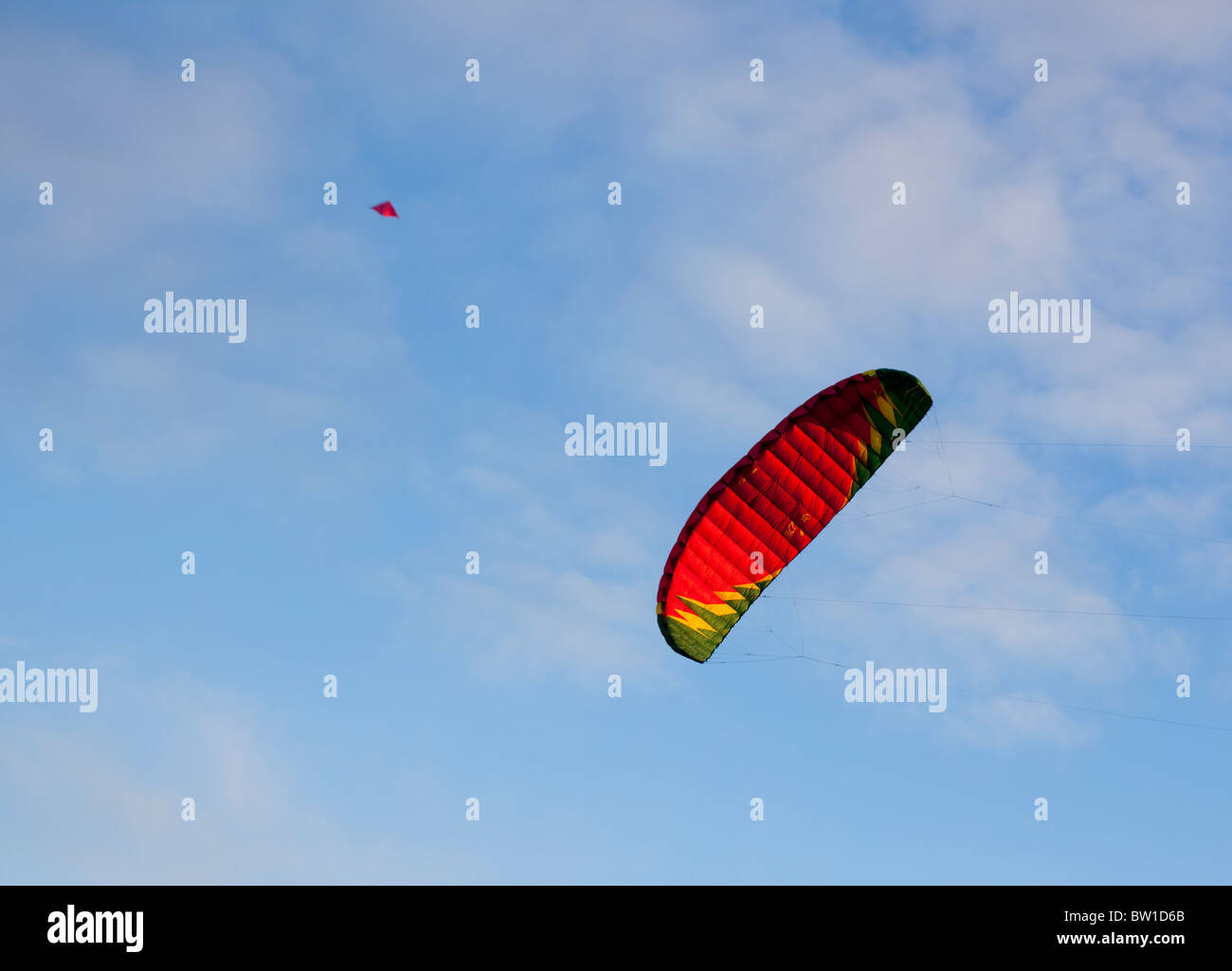 Kite flying in a blue sky with clouds, England, UK Stock Photo - Alamy