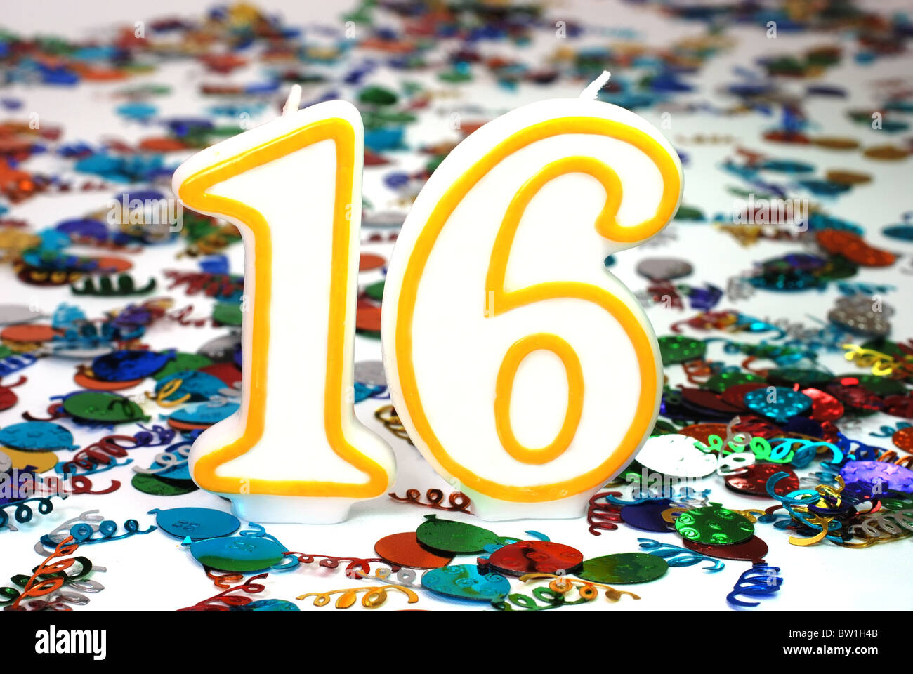 Number 16 celebration candle with confetti Stock Photo - Alamy