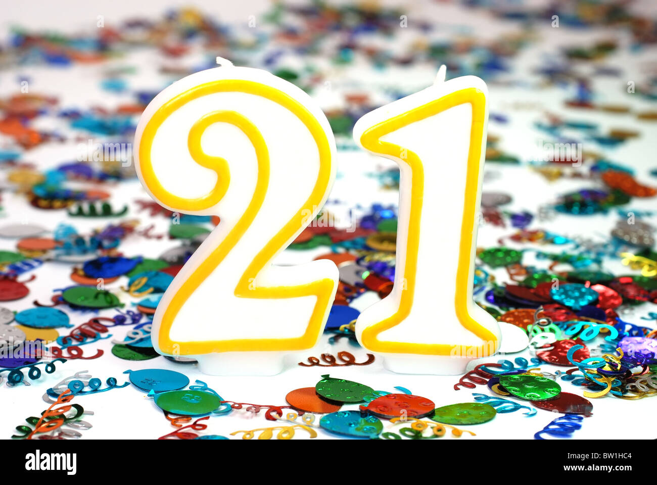 Number 21 celebration candle with confetti Stock Photo - Alamy