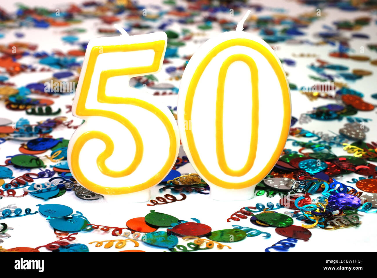 Number 50 celebration candle with confetti Stock Photo - Alamy