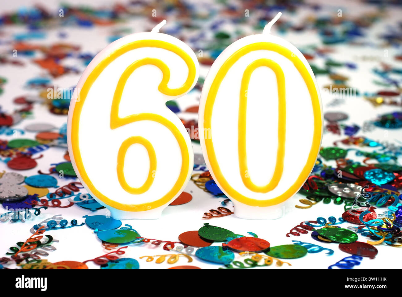 Number 60 celebration candle with confetti Stock Photo - Alamy