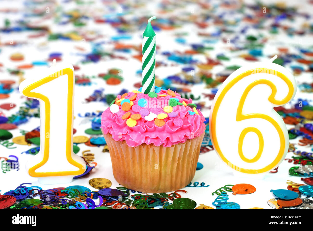 Number 16 celebration cupcake with candle and sprinkles with confetti ...